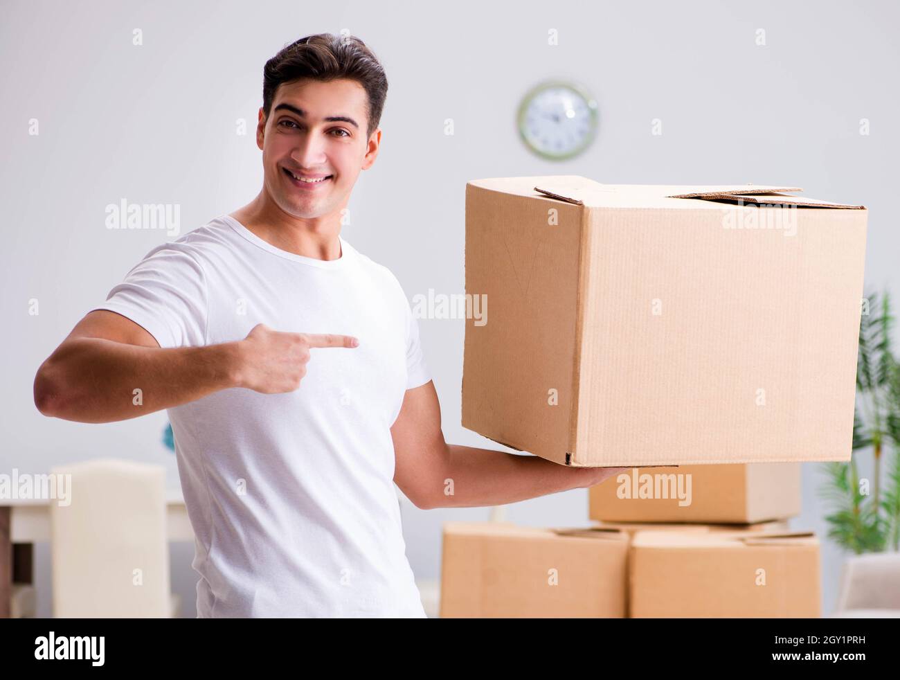 The young man moving boxes at home Stock Photo - Alamy