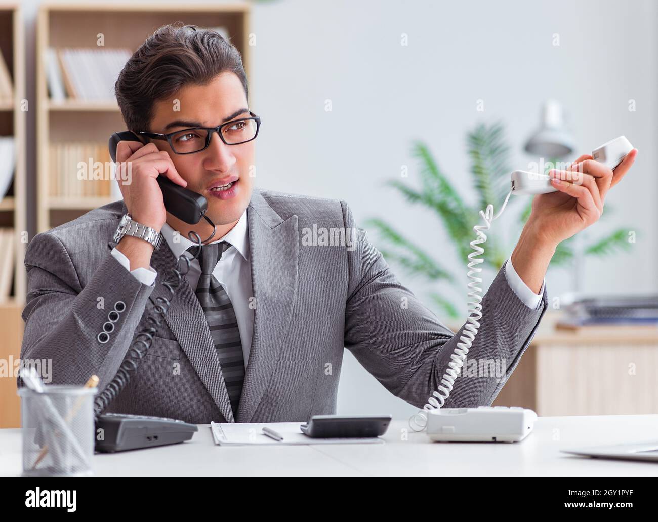 The angry helpdesk operator in the office Stock Photo - Alamy