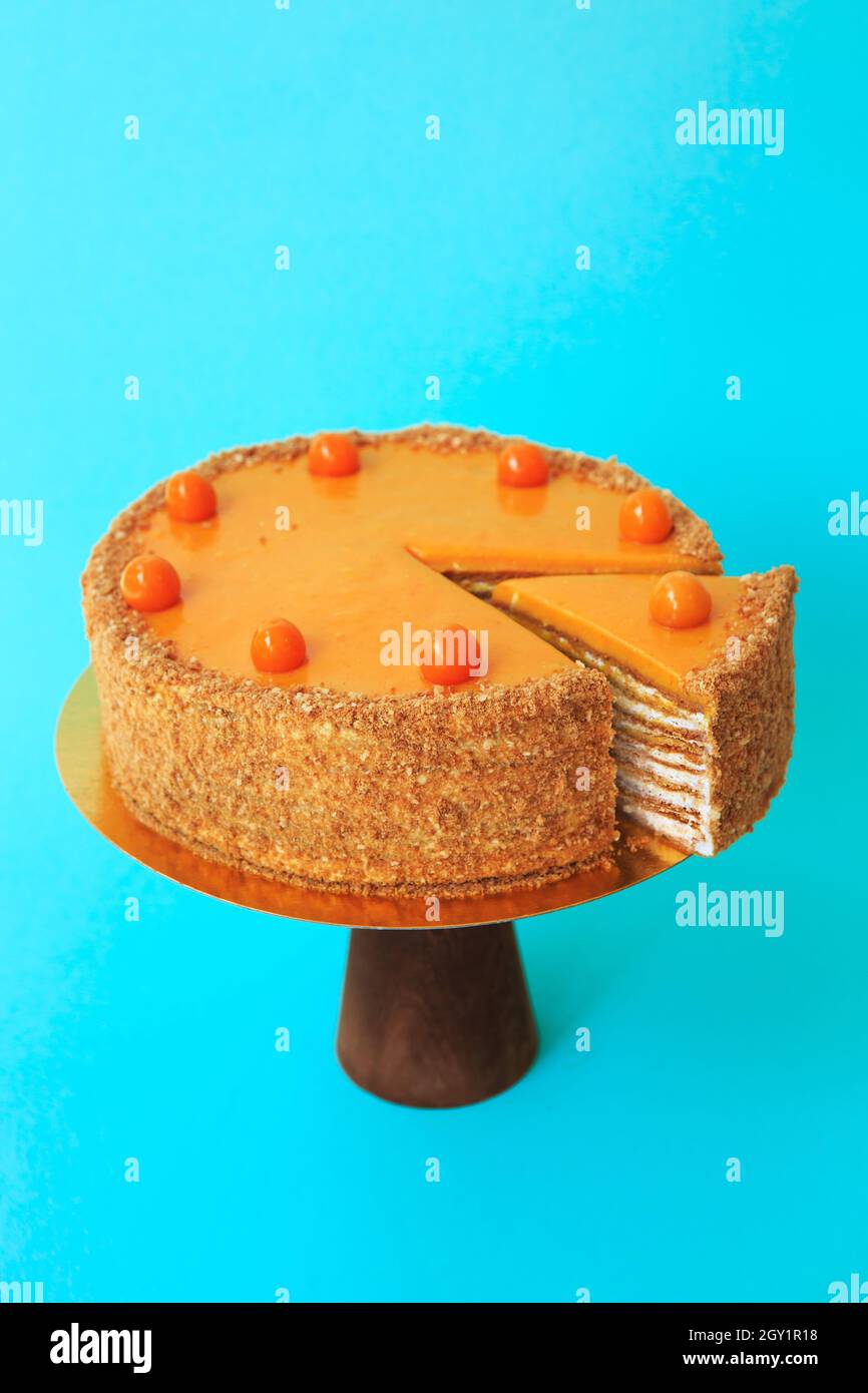 Sliced Birthday cake on the wooden cake stand. Beautiful sponge cake ...