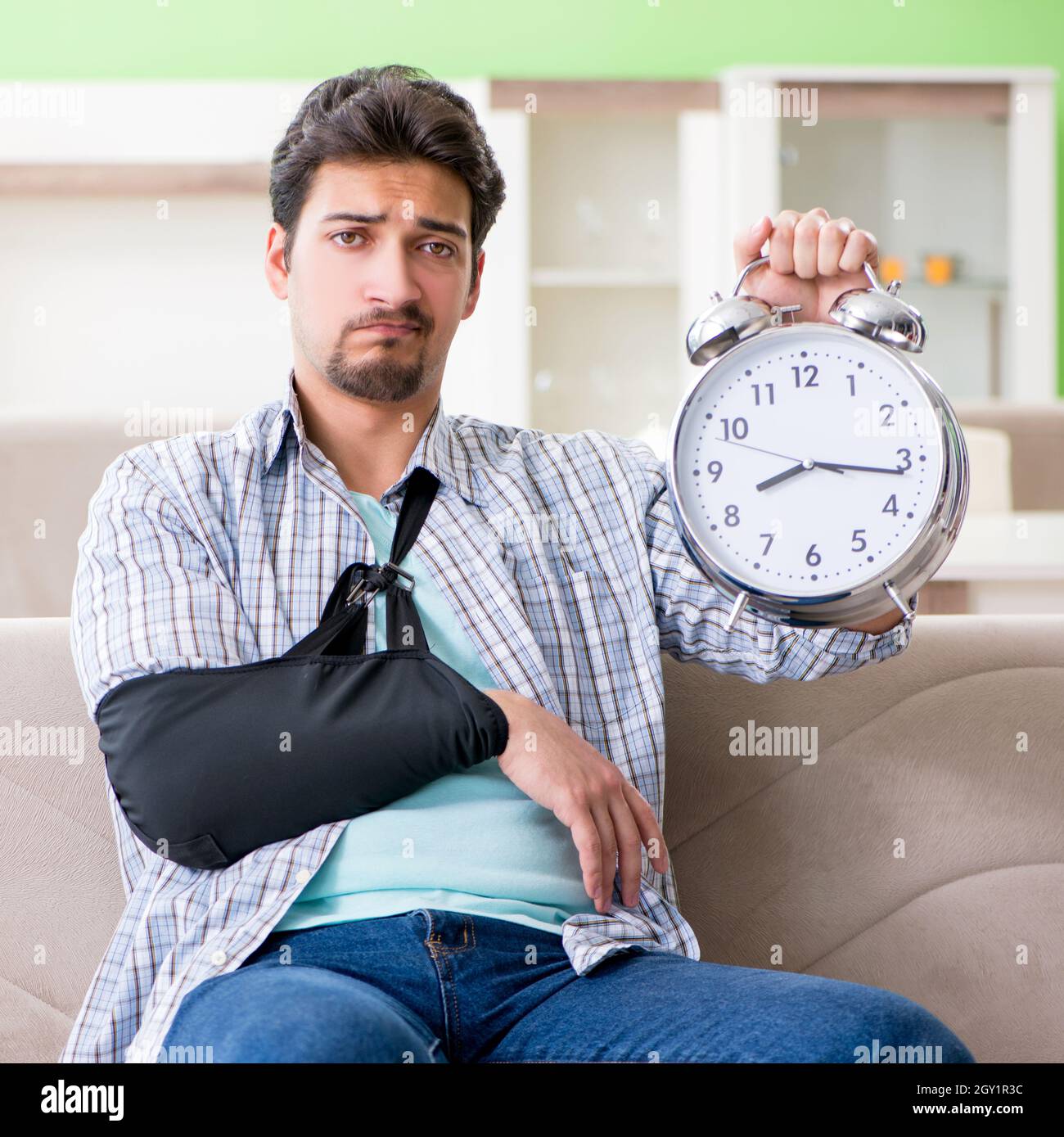 Young student with hand injury in time management concept Stock Photo ...
