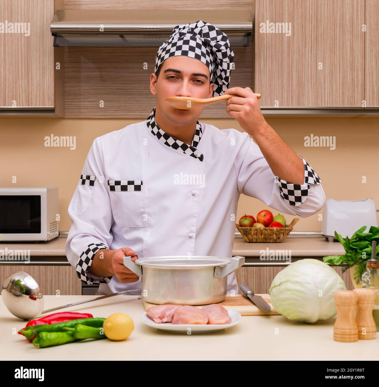 The young chef working in the kitchen Stock Photo - Alamy