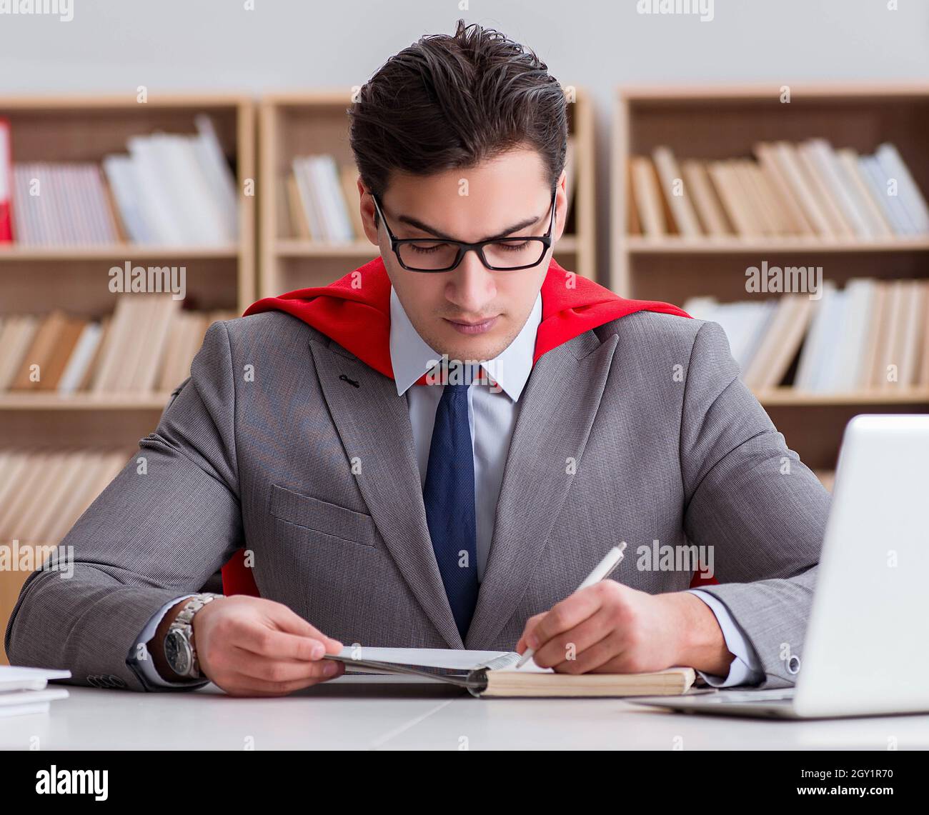 The superhero businessman working in the office Stock Photo - Alamy