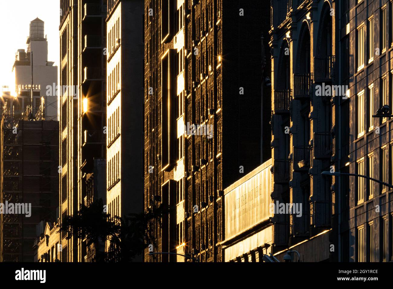 Sunlight casting shadows on a block of historic buildings in Manhattan ...