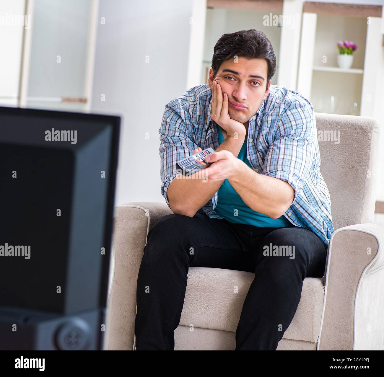 The man watching tv at home Stock Photo - Alamy