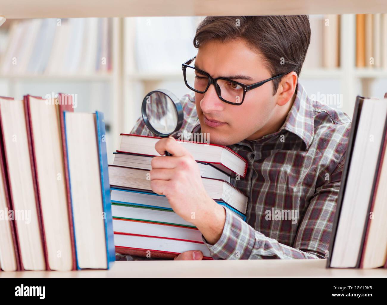 The young student looking for books in college library Stock Photo - Alamy