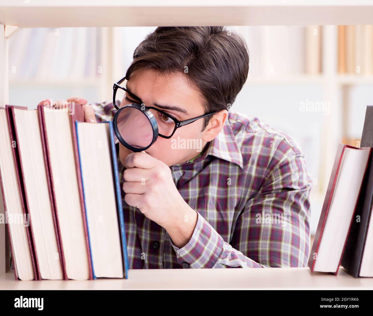 The young student looking for books in college library Stock Photo - Alamy