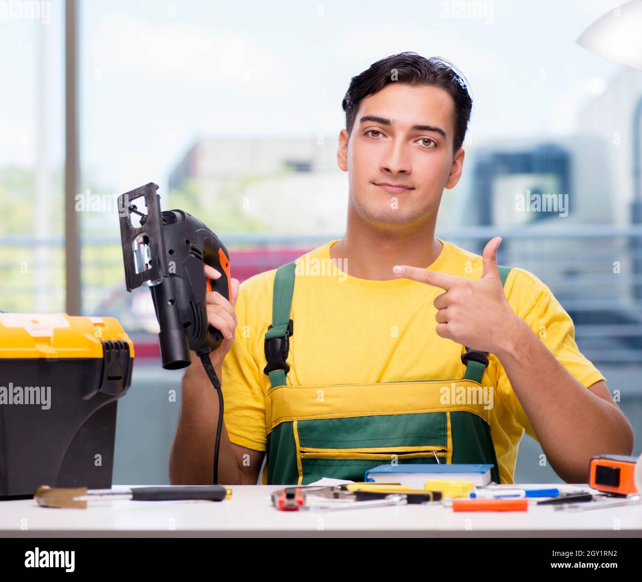 The construction worker sitting at the desk Stock Photo - Alamy