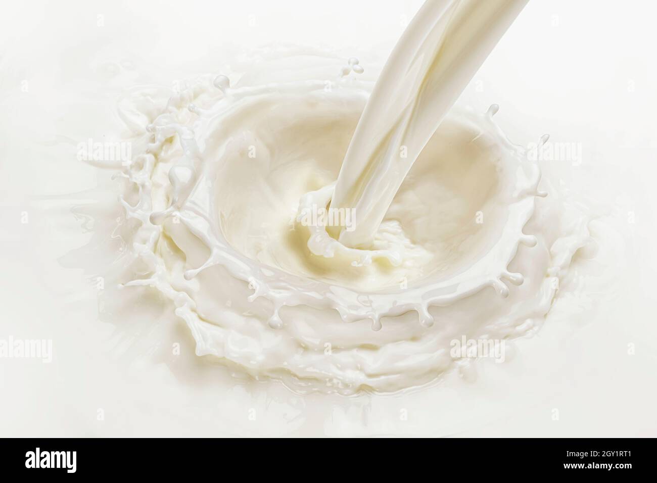 Pouring milk splash on white background Stock Photo - Alamy