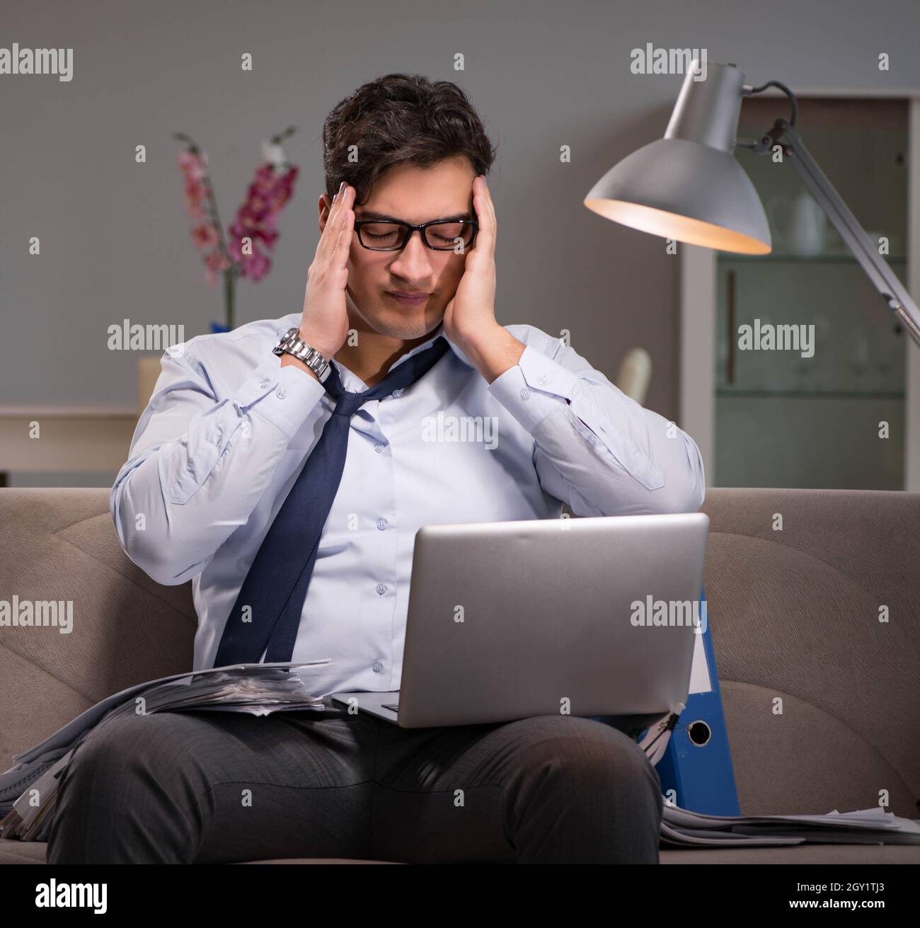 The businessman workaholic working late at home Stock Photo - Alamy