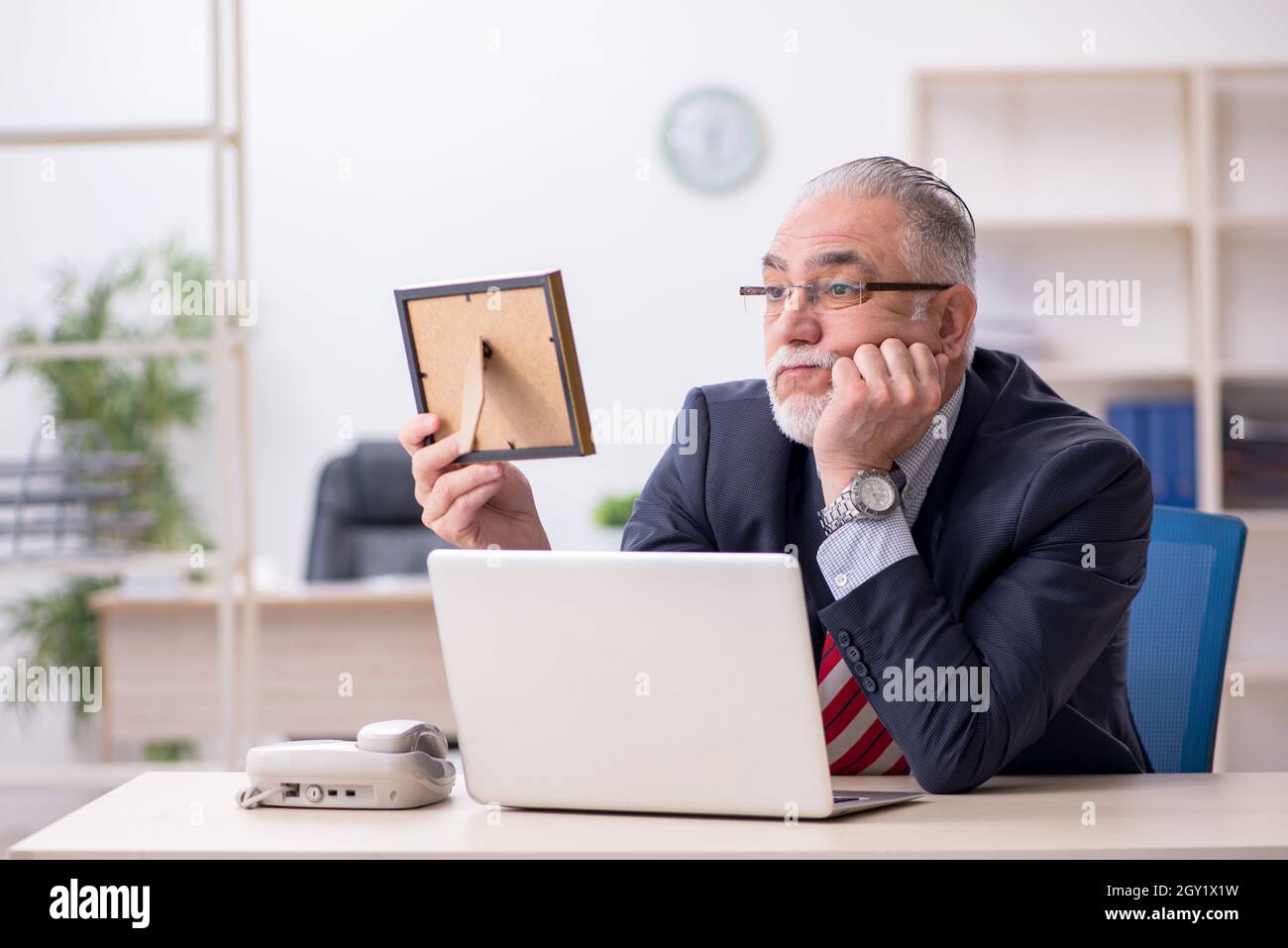 Old businessman employee missing wife at workplace Stock Photo - Alamy