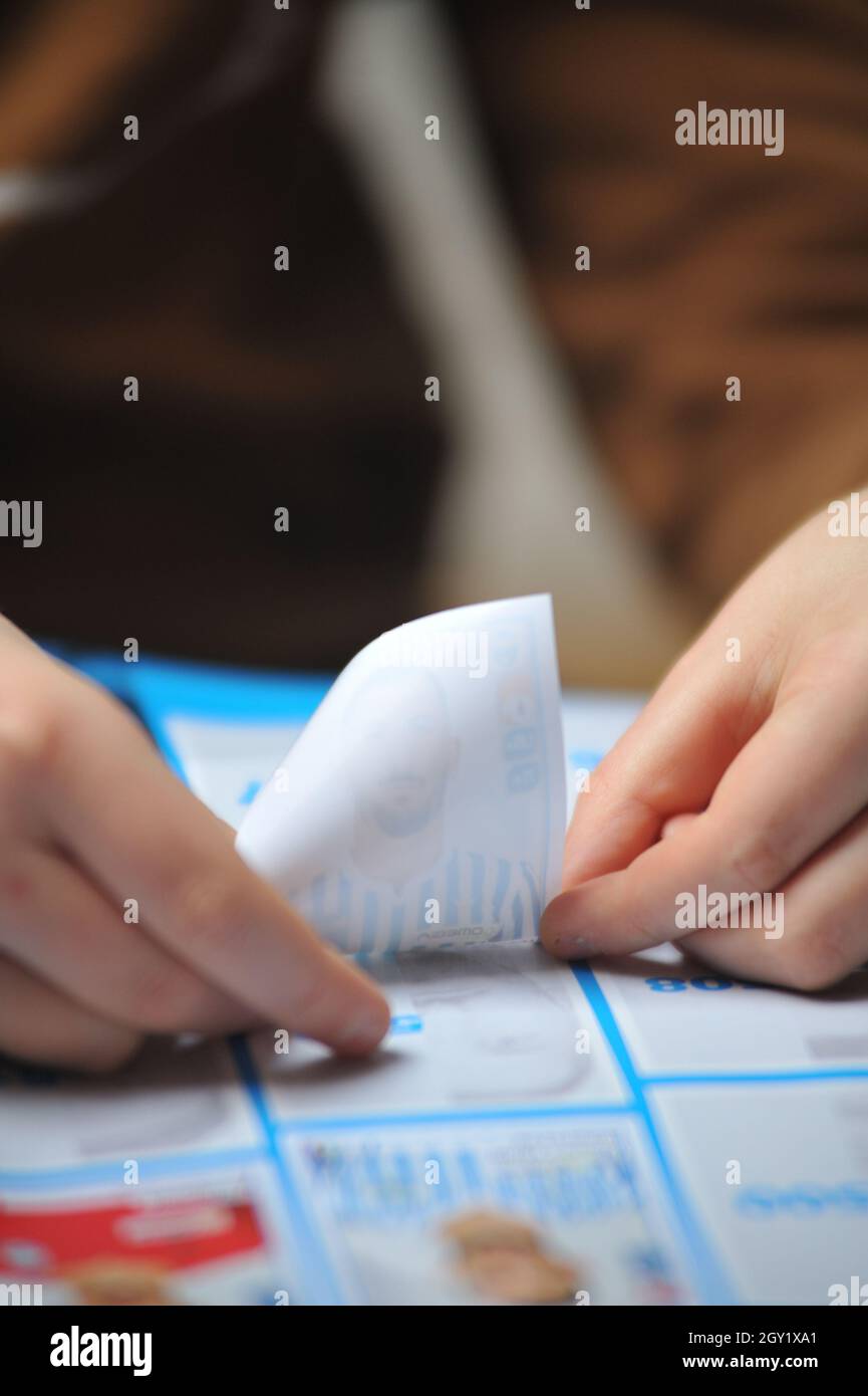Closeup shot of a child putting stickers in a book Stock Photo - Alamy