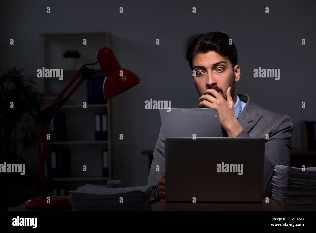 Young employee working late in the office Stock Photo - Alamy