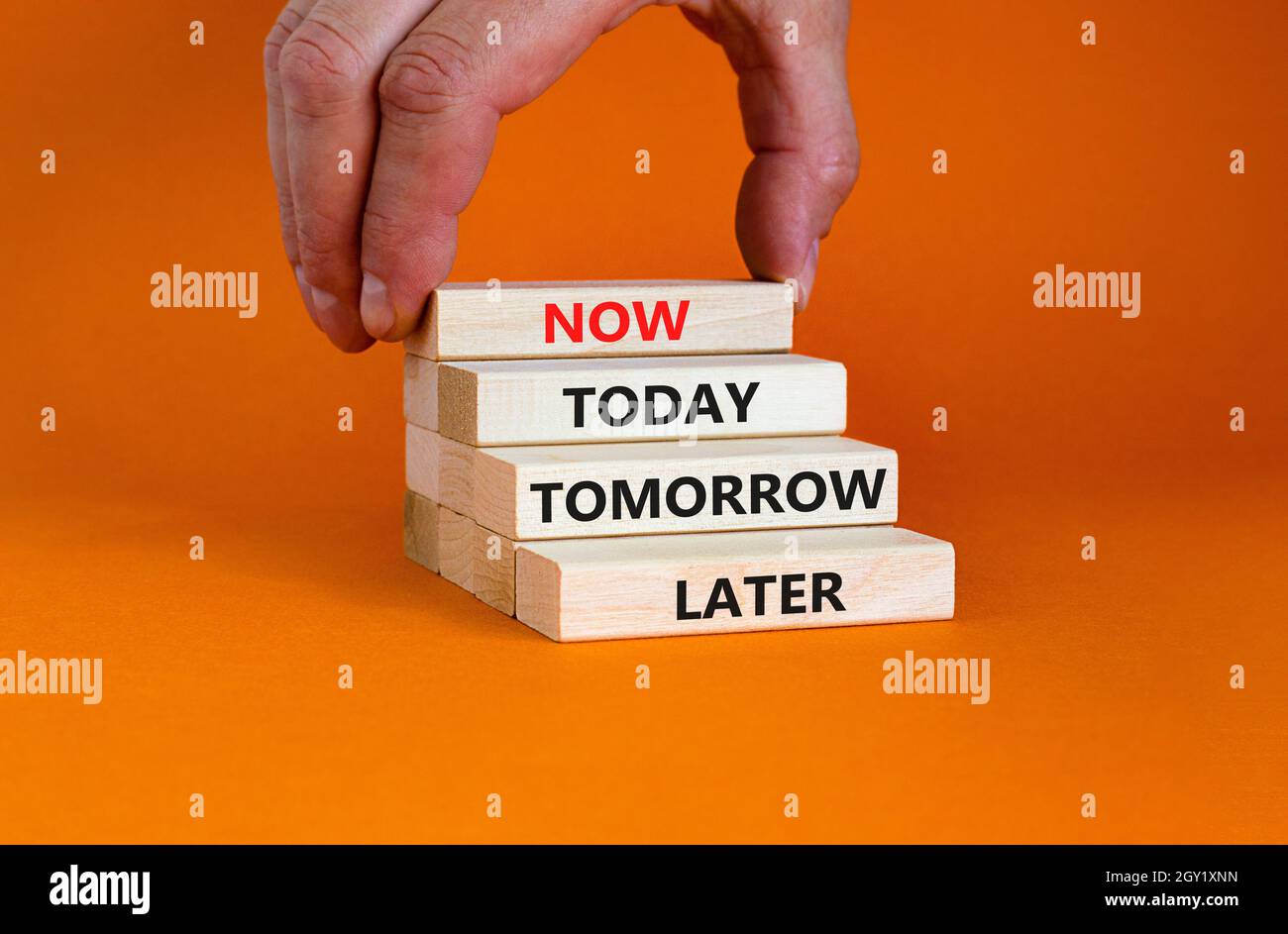 Now or never symbol. Wooden bloks with words 'later, tomorrow, today ...