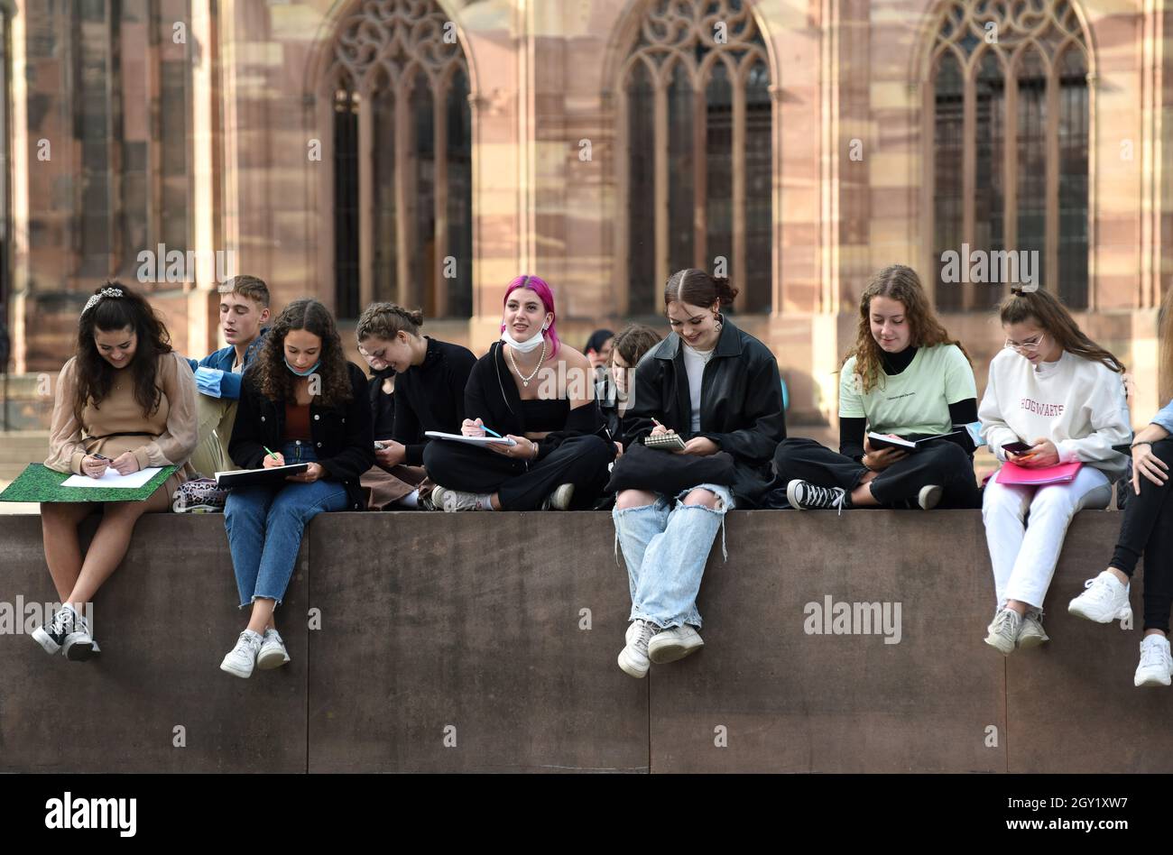French students studying outdoors on location in Strasbourg France ...