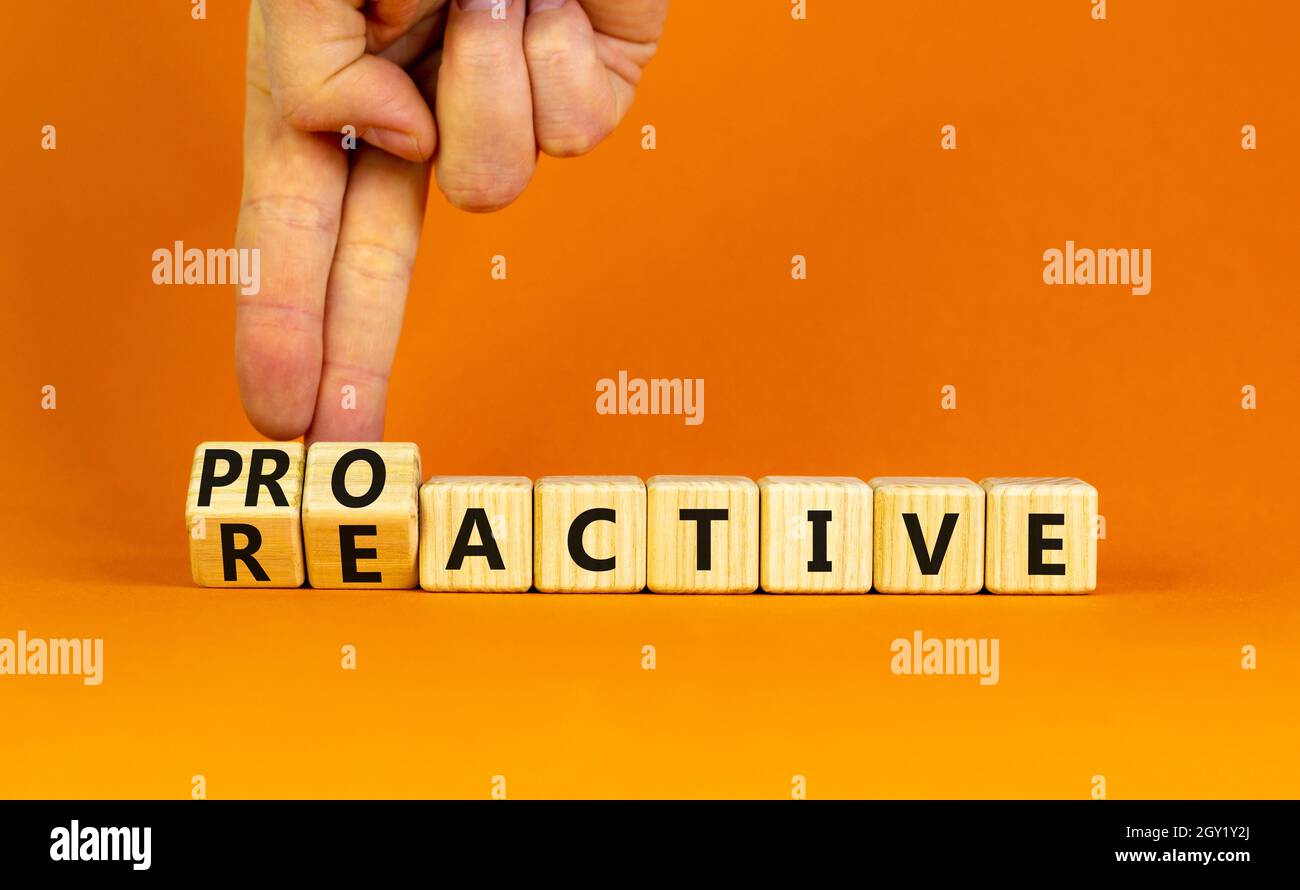 Reactive or proactive symbol. Businessman turns wooden cubes and ... Reactive or proactive symbol. Businessman turns wooden cubes and ...