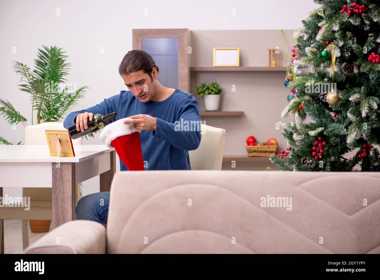 Young man celebrating new year alone at home Stock Photo - Alamy
