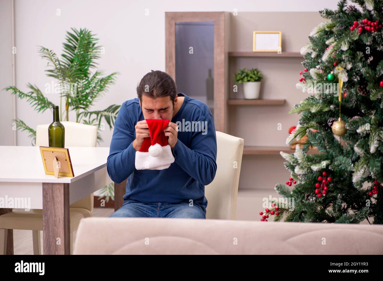 Young man celebrating new year alone at home Stock Photo - Alamy
