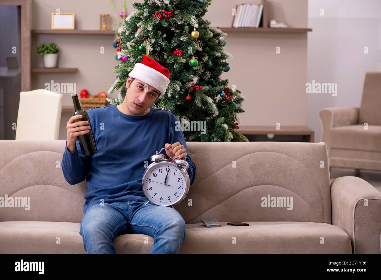 Young man celebrating new year alone at home Stock Photo - Alamy