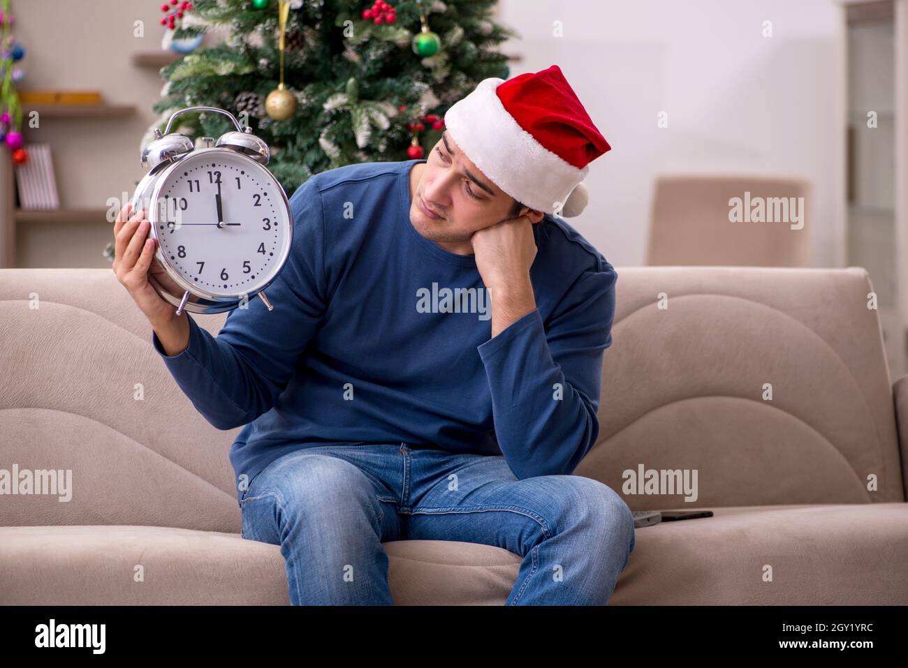 Young man celebrating new year alone at home Stock Photo - Alamy