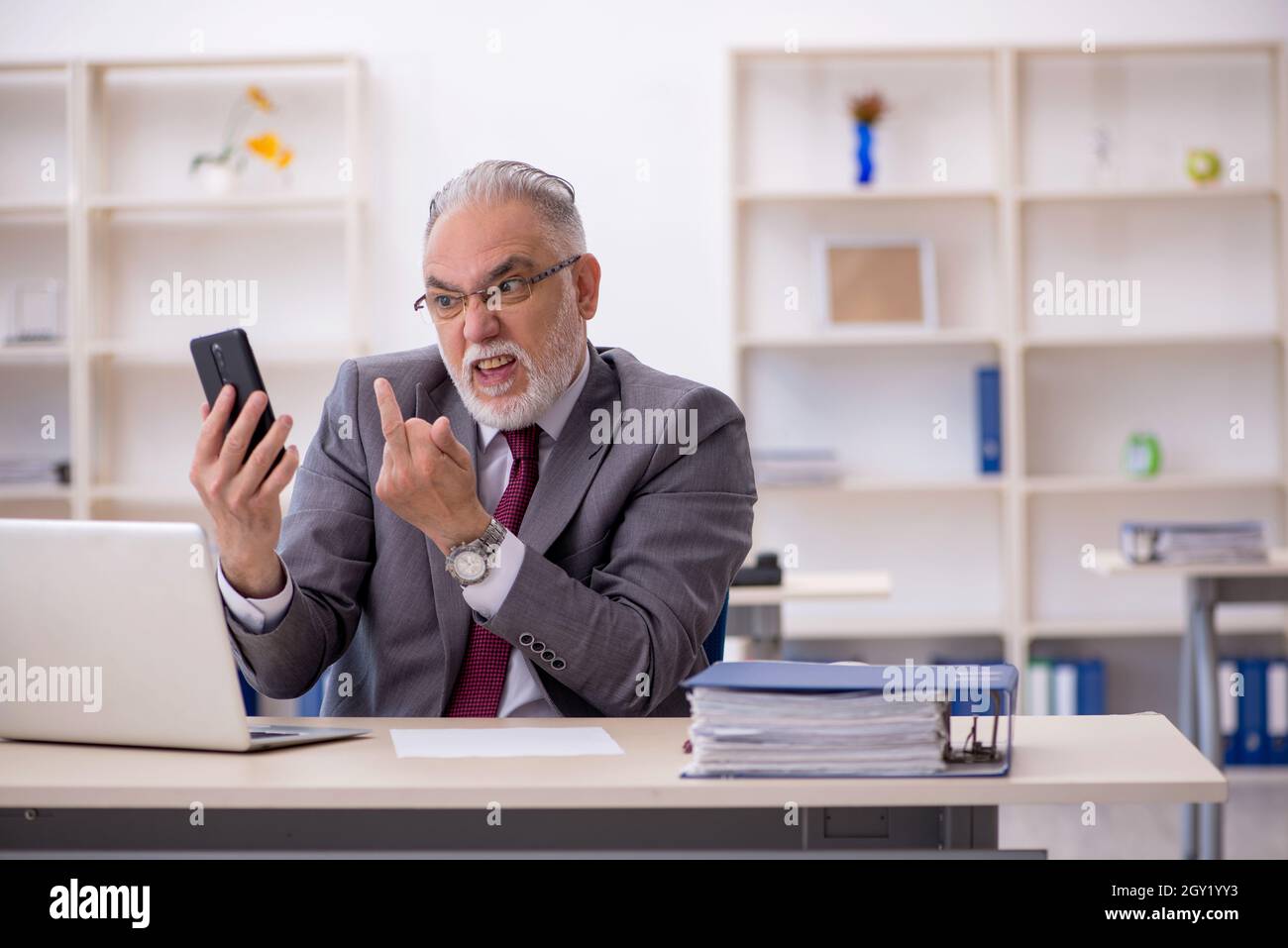 Old employee working in the office Stock Photo - Alamy