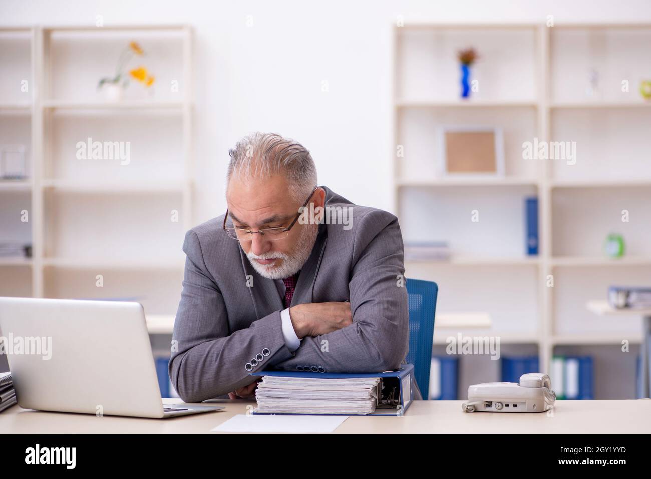 Old employee working in the office Stock Photo - Alamy