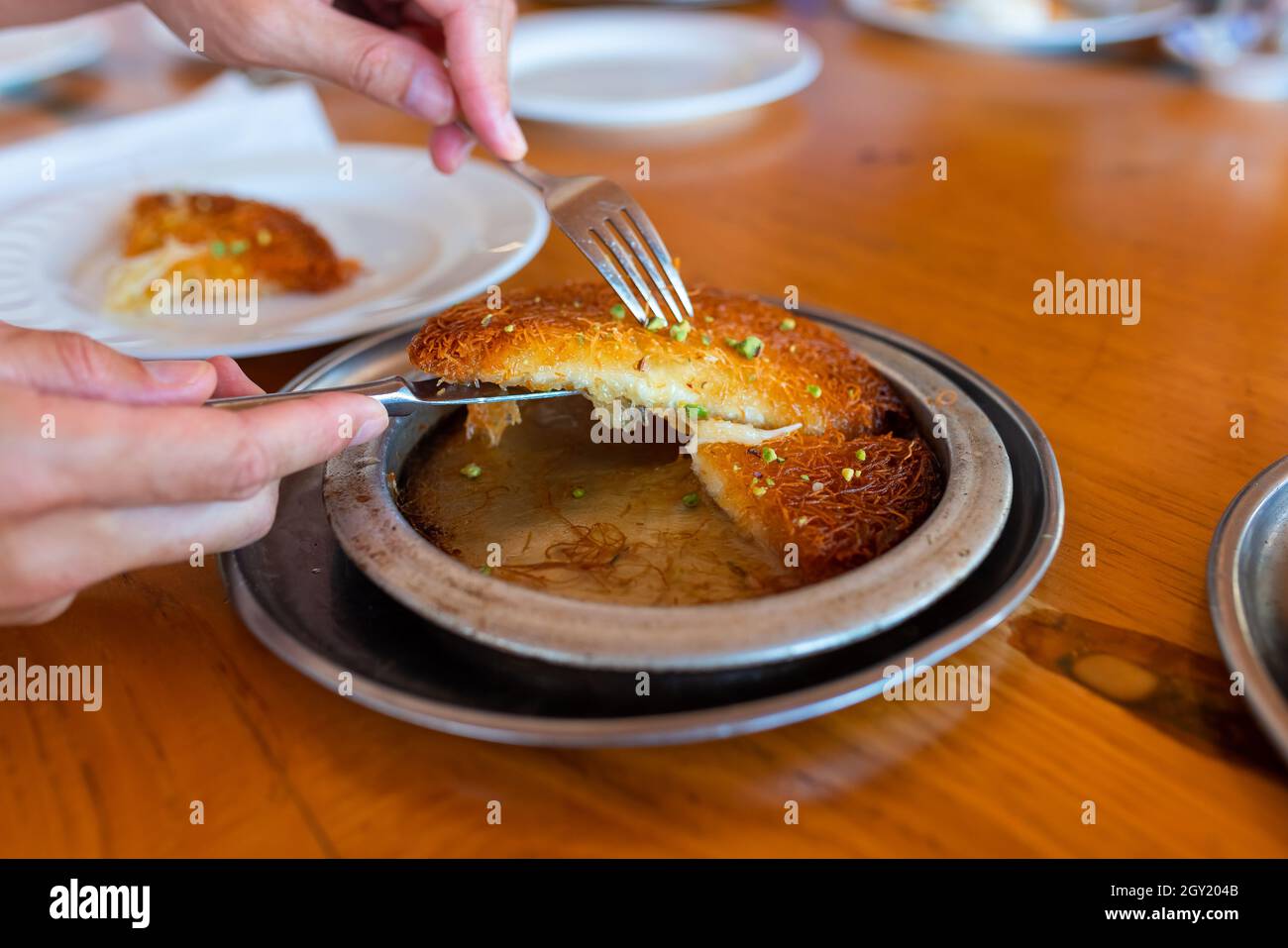 Turkish dessert kunefe, kunafa, kadayif with pistachio powder and ...