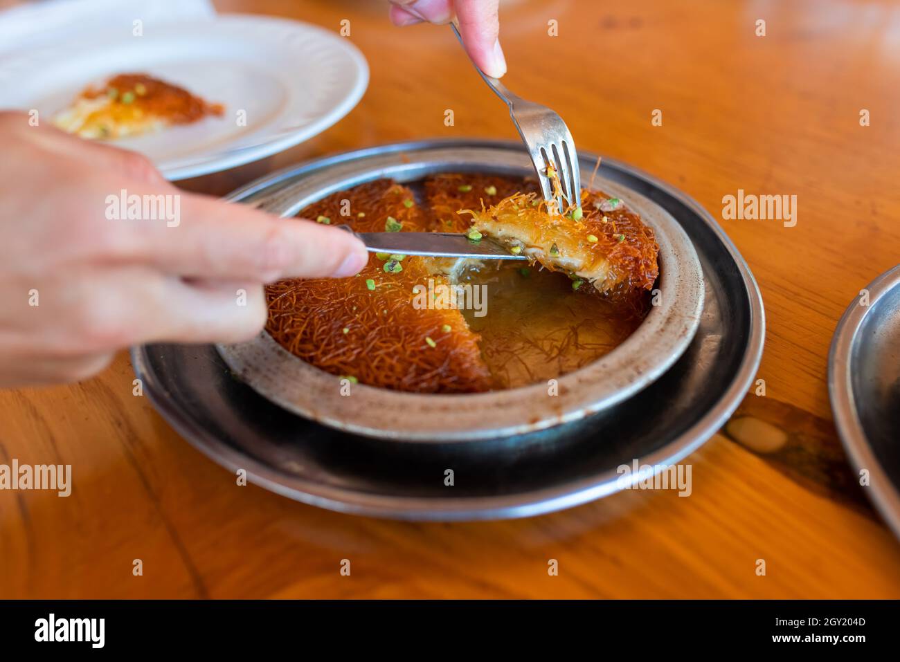 Turkish dessert kunefe, kunafa, kadayif with pistachio powder and ...