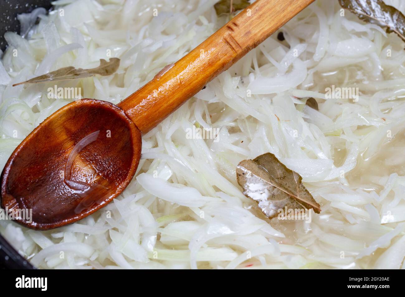 pot full of sliced onions boiling with bay leaves and pepper Stock ...