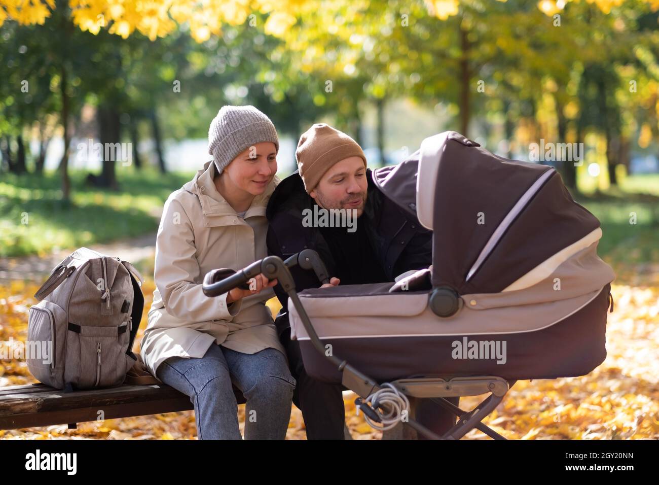 Happy young mother with pram during the walk Stock Photo - Alamy