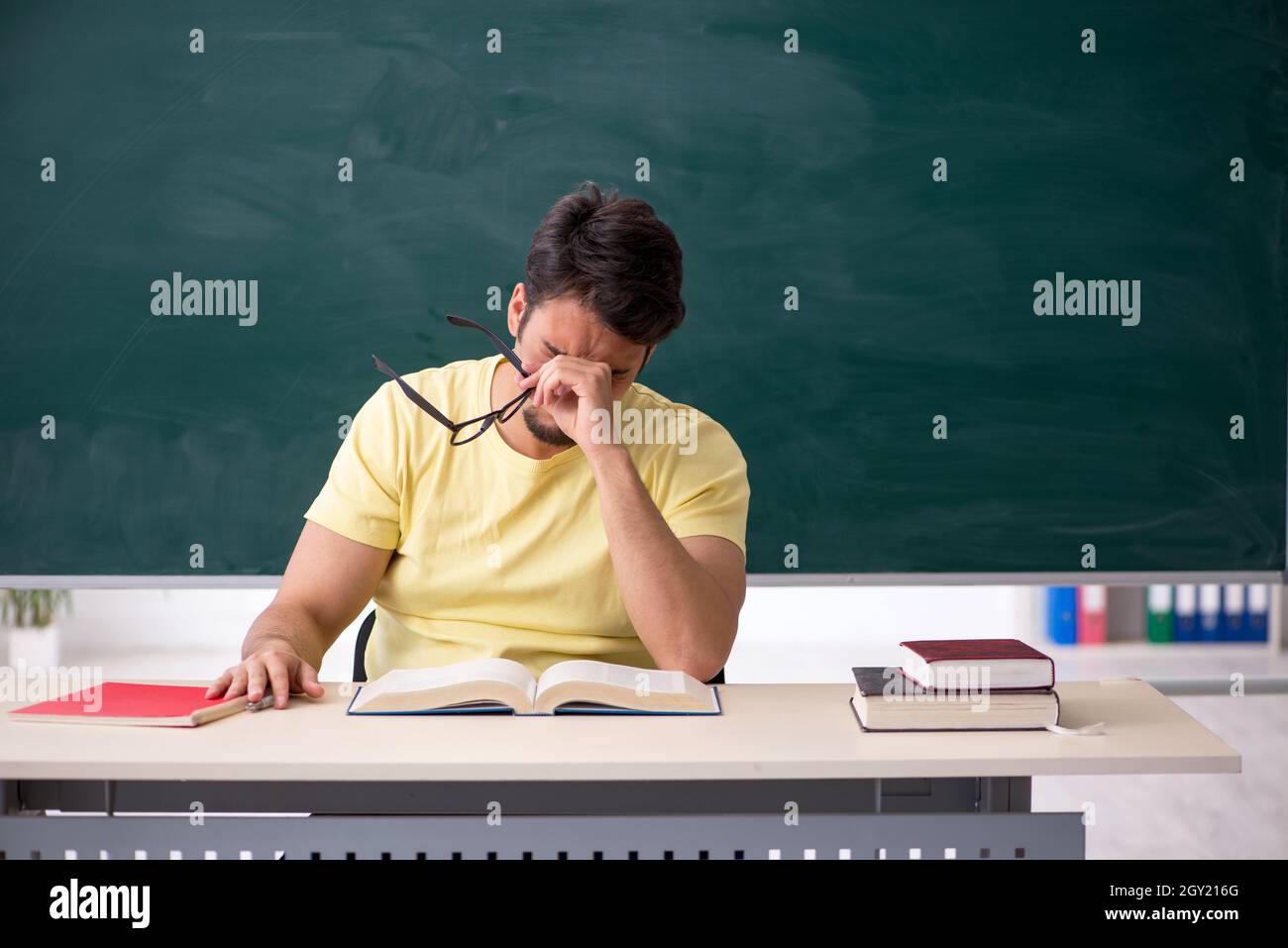 Young student in front of blackboard Stock Photo - Alamy
