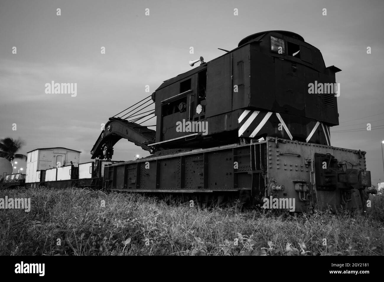 A black and white photography of an old wrecker in the sunset, parked ...
