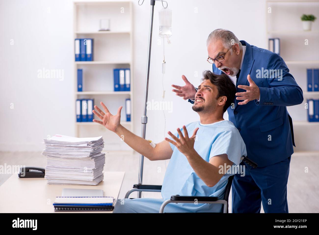Young employee in wheel-chair feeling bad at workplace Stock Photo - Alamy