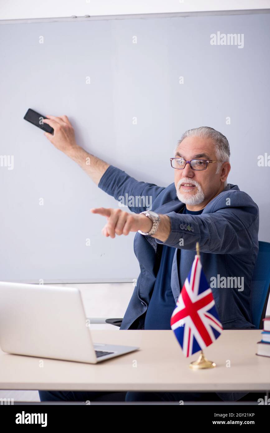 Old english language teacher in the classroom Stock Photo - Alamy