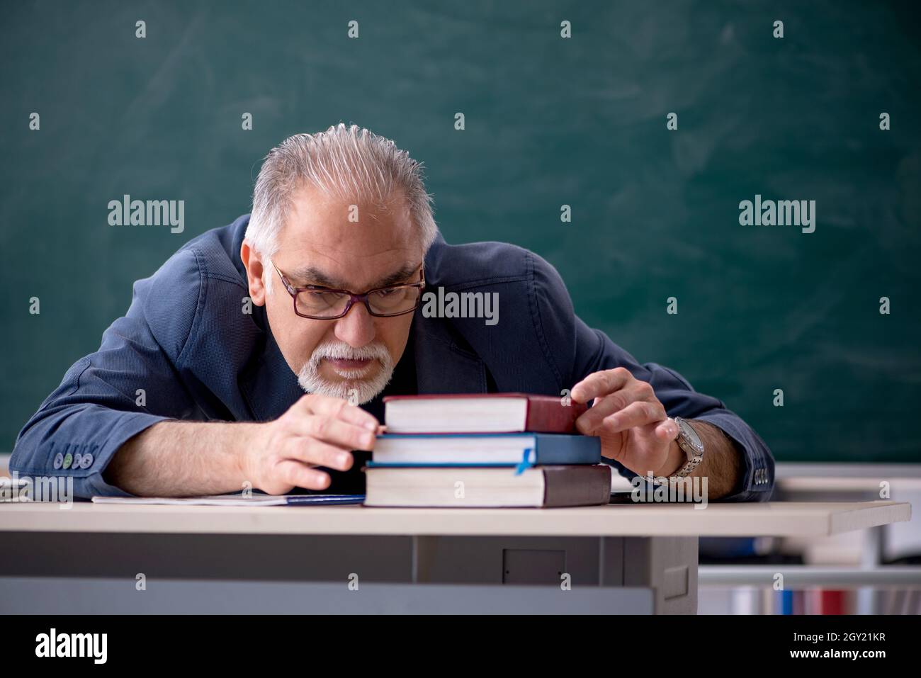 Old teacher in the classroom Stock Photo - Alamy