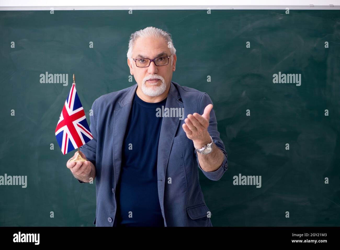 Old english language teacher in the classroom Stock Photo - Alamy