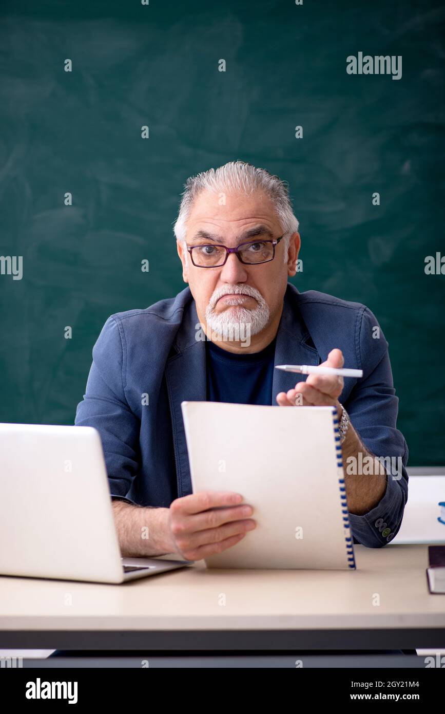 Old teacher in the classroom Stock Photo - Alamy