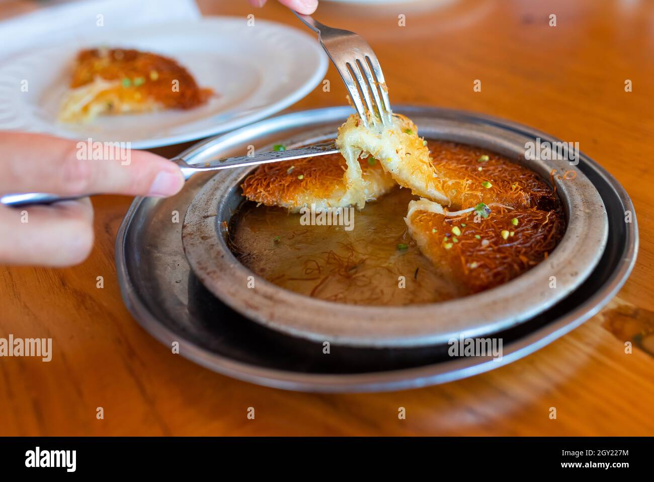 Turkish dessert kunefe, kunafa, kadayif with pistachio powder and ...