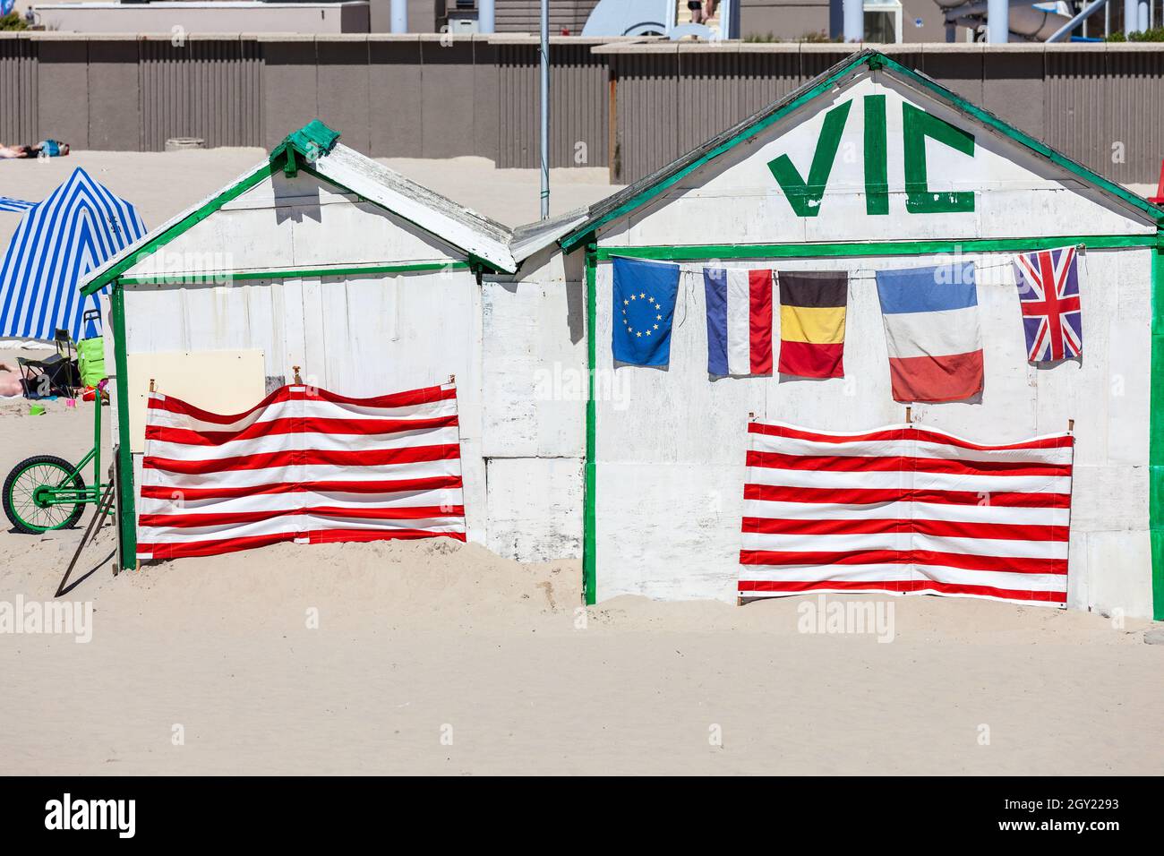 Two beach huts decorated with flags Stock Photo - Alamy
