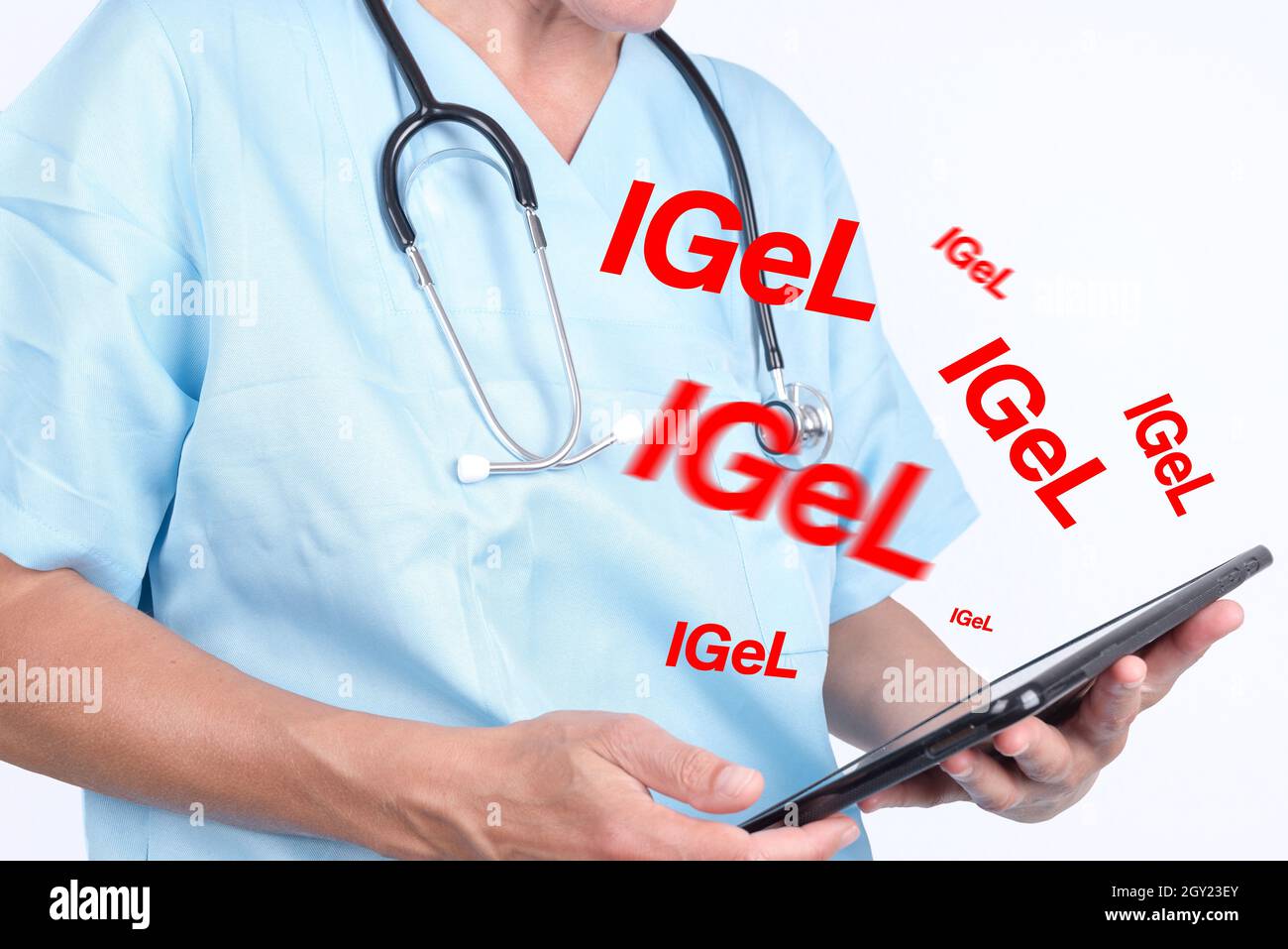 Doctors torse wearing a blue medical shirt, holding a tablet with signs ...