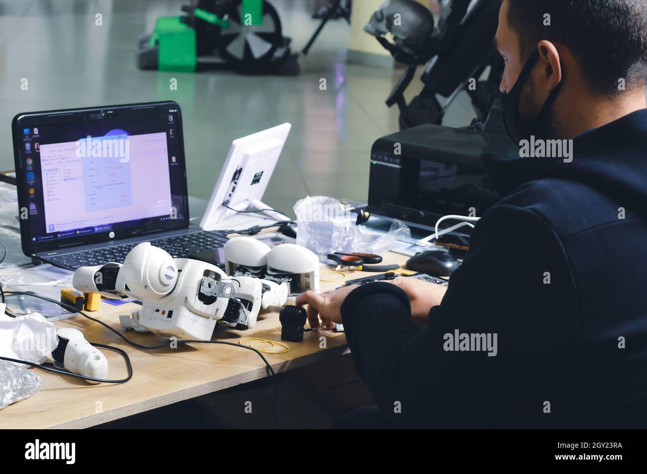 man repairing a robot. Close up of man fixing a broken little robot ...