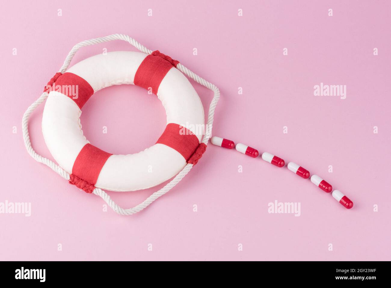 Small toy lifebuoy isolated on the pink background Stock Photo - Alamy