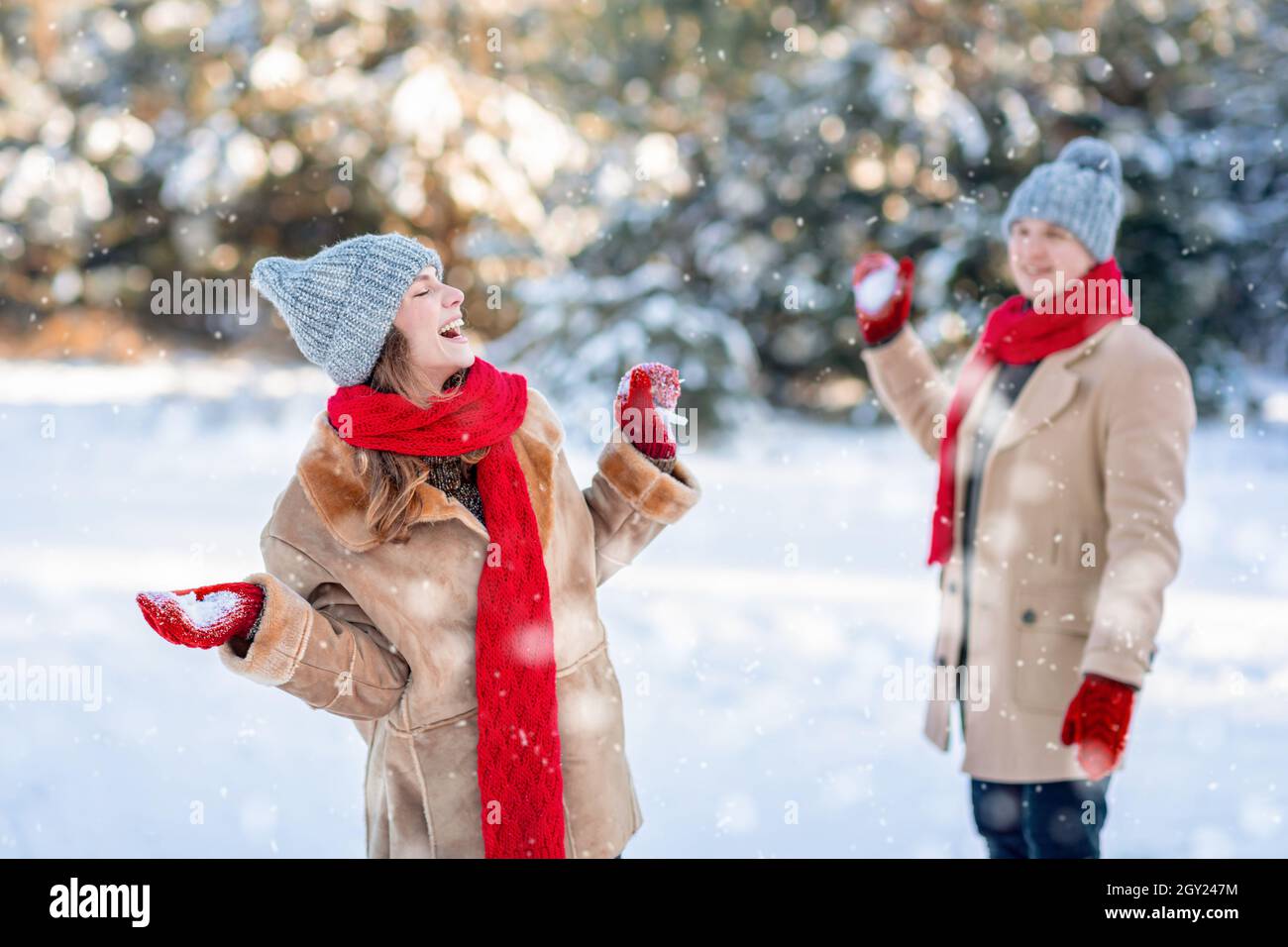 Happy loving couple having snow fight at winter park Stock Photo - Alamy