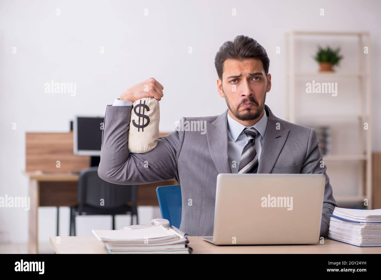 Young businessman employee in remuneration concept Stock Photo - Alamy