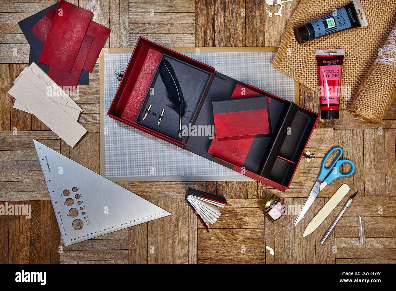 Black and red box with many compartments open on a table with many ...