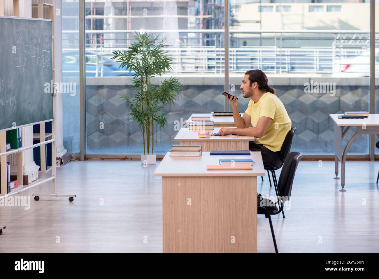 Male student sitting in the classroom Stock Photo - Alamy