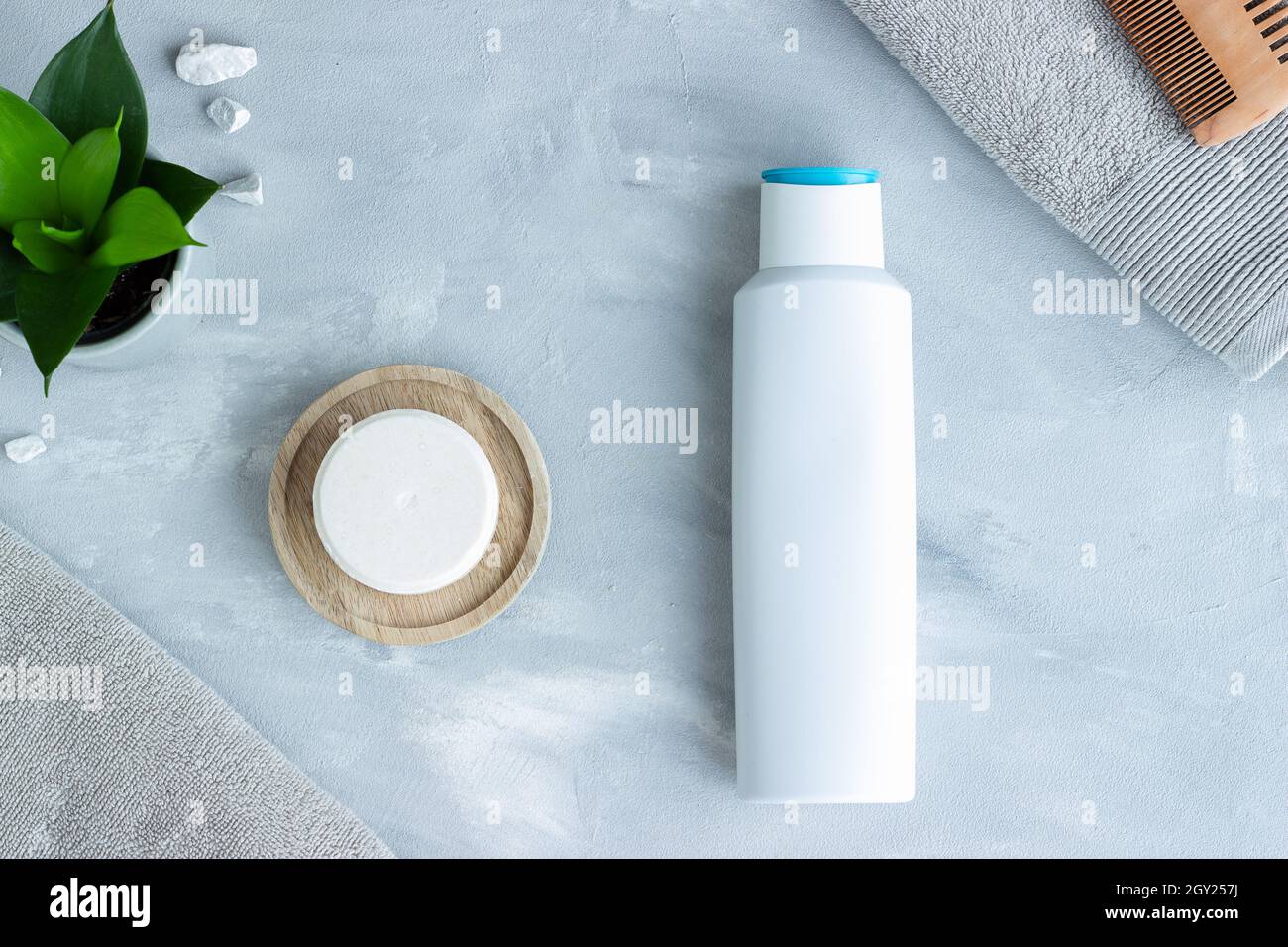 Bar of shampoo and plastic bottle of shampoo side by side; sustainable ...