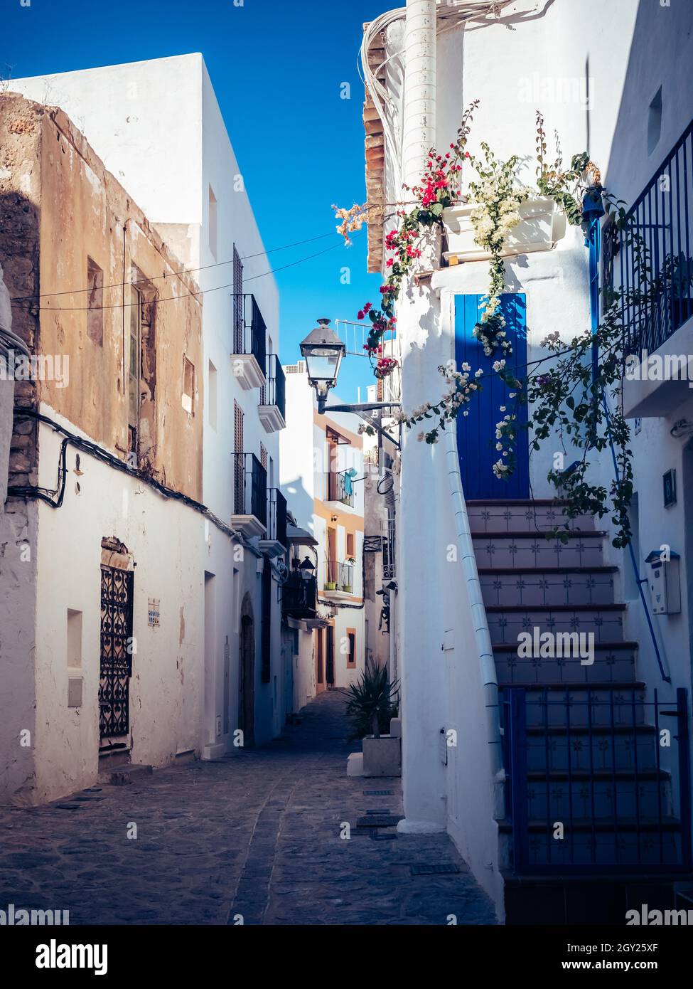 Footpath between traditional buildings in Ibiza, Spain Stock Photo - Alamy