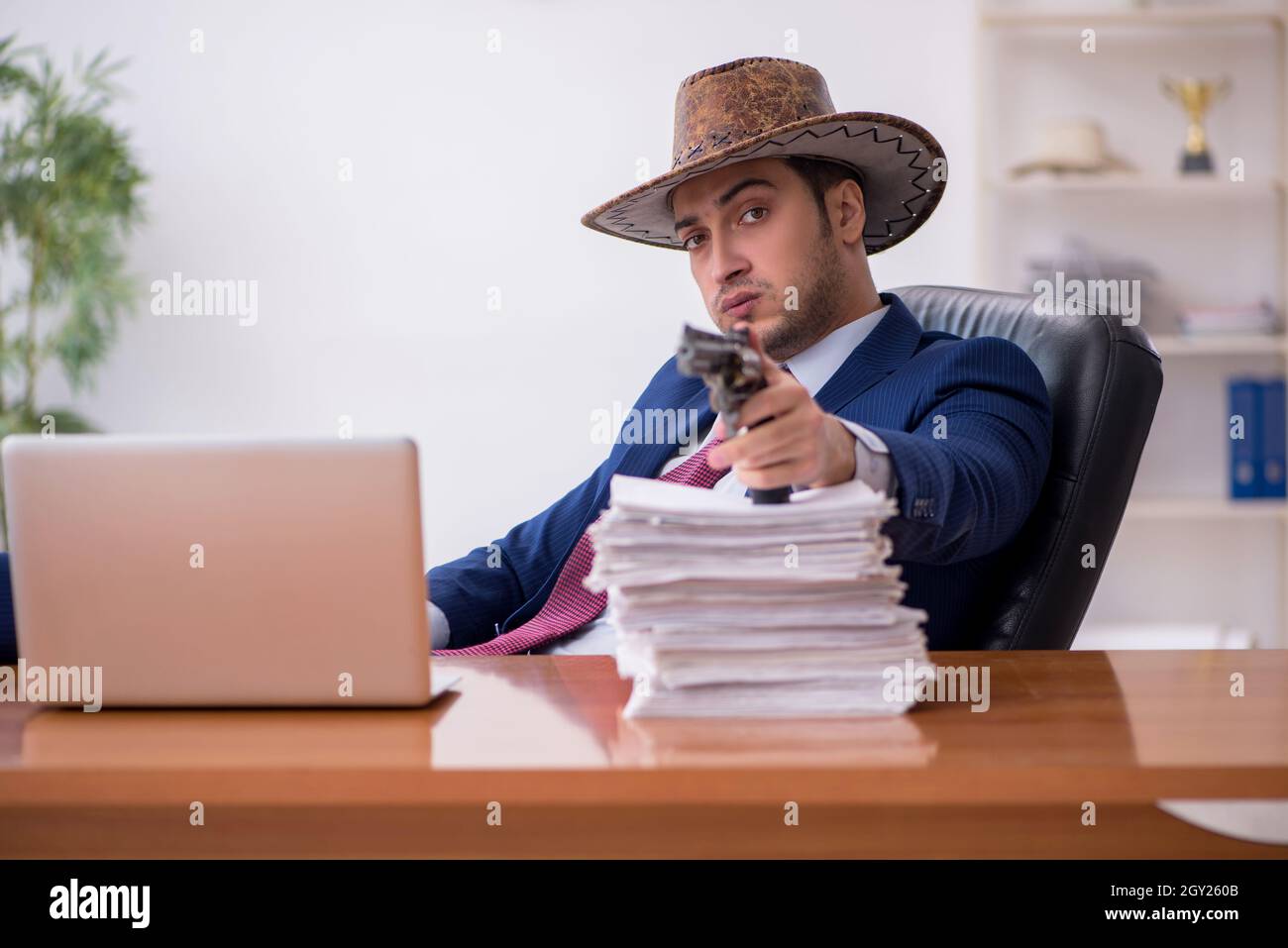 Young cowboy employee working at workplace Stock Photo - Alamy