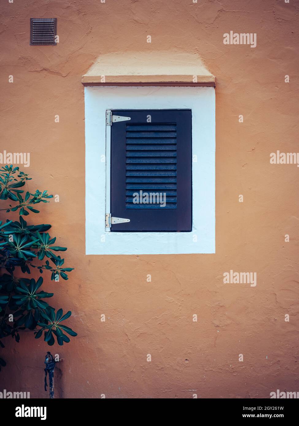 Closed small window of a building Stock Photo - Alamy