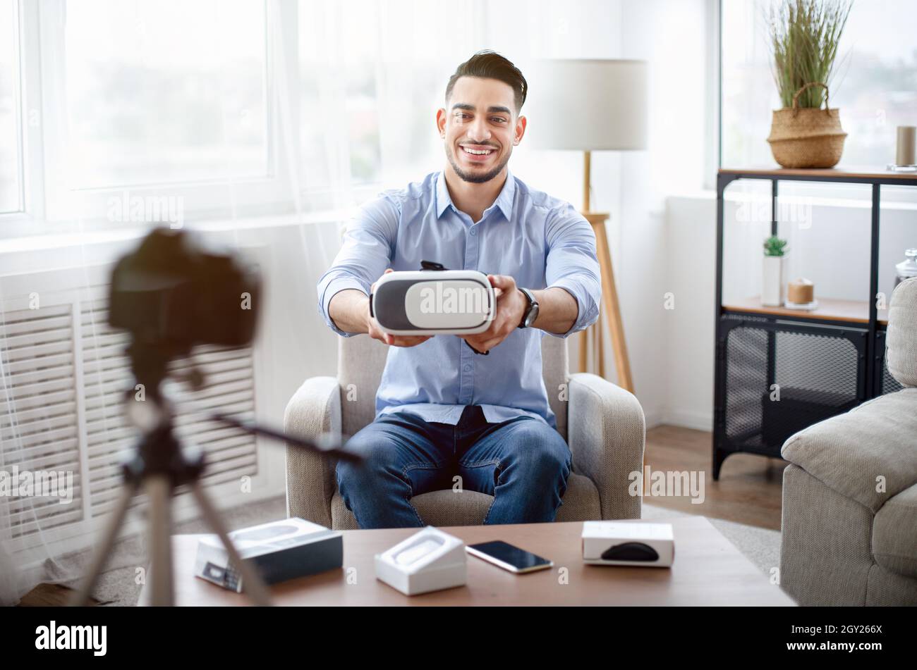 Arab male vlogger showing VR headset, making product review, recording ...